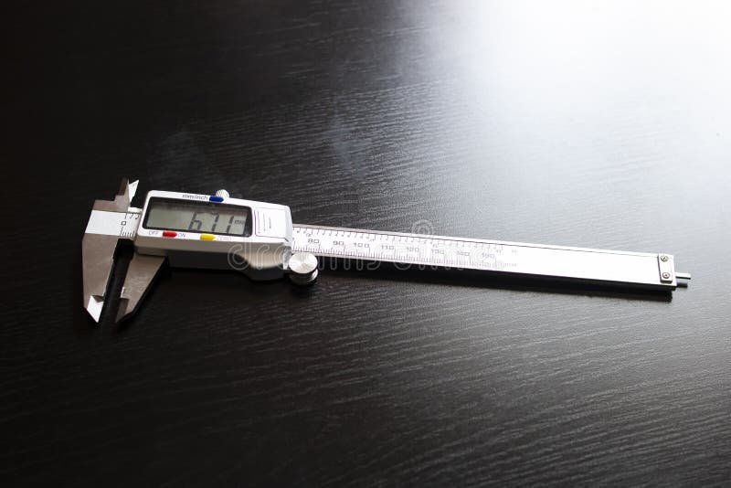 Electronic Vernier Caliper on a Wooden Table Stock Image - Image of ...