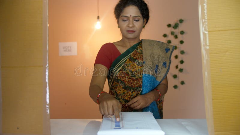 A Middle-aged Lady / Female Candidate Casting Her Vote at a Voting ...