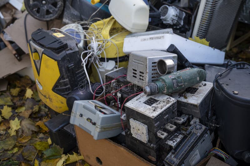 Electronic Waste Awaiting Recycling. a Pile of Garbage in Nature. Green ...