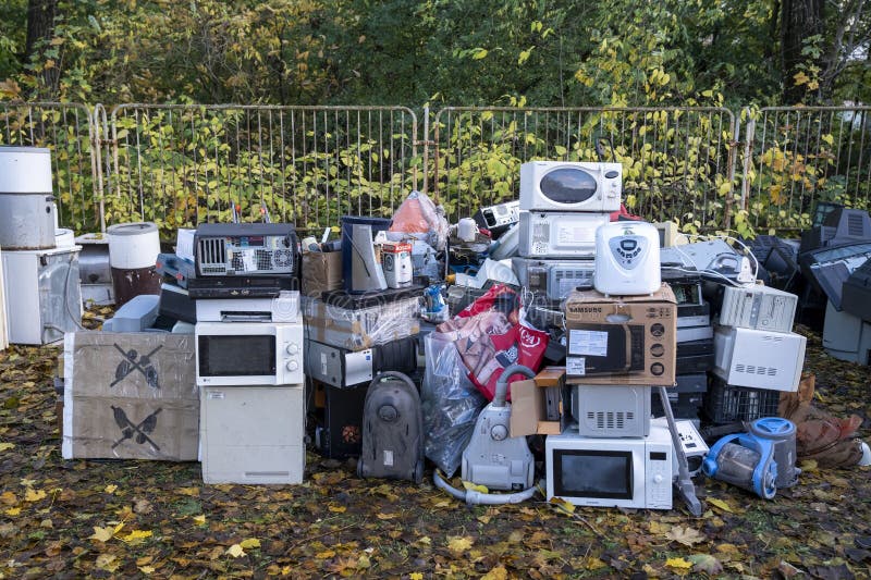 Electronic Waste Awaiting Recycling. a Pile of Garbage in Nature. Green ...