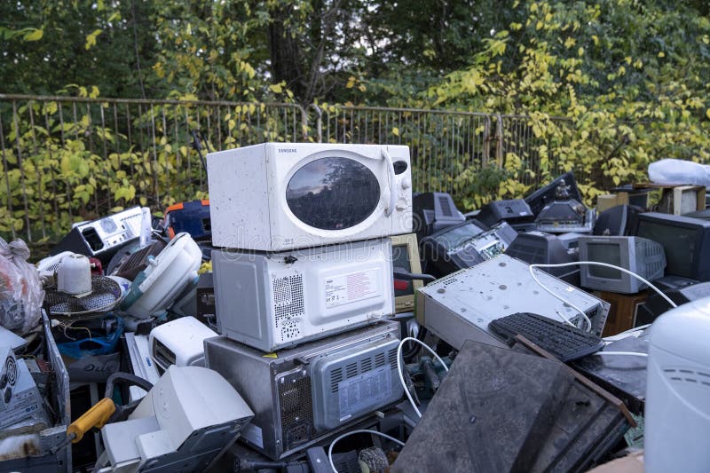 Electronic Waste Awaiting Recycling. a Pile of Garbage in Nature. Green ...