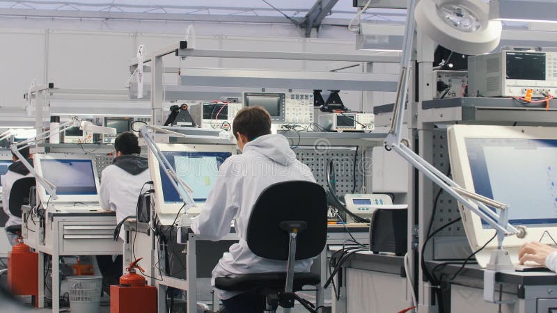 Electronics Engineers in White Clothes Working in Lab. Engineers ...