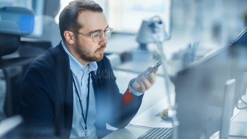 Electronics Factory: Male Electrical Engineer Holds PCB Prototype ...