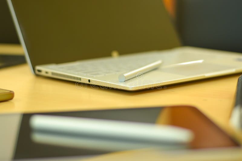 Electronics Items on a Table, Tablet, Laptop, Pencil, Pen, Mobile and a ...