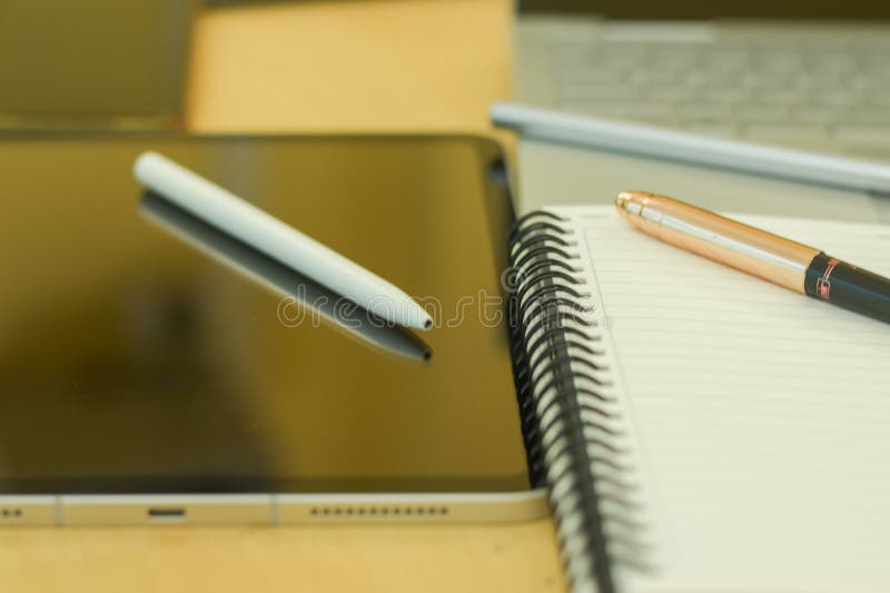 Electronics Items on a Table, Tablet, Laptop, Pencil, Pen and a Note ...