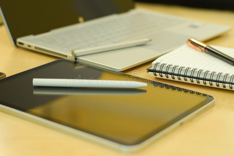 Electronics Items on a Table, Tablet, Laptop, Pencil, Pen and a Note ...
