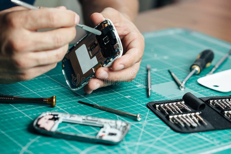 Electronics Repair Service. Technician Disassembling Smartphone for ...
