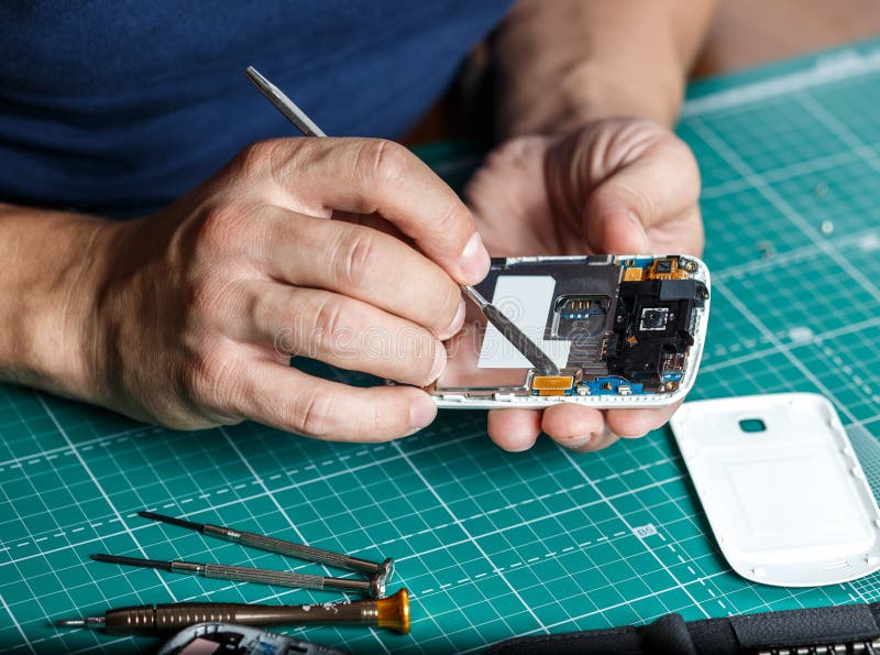 Electronics Repair Service. Technician Disassembling Smartphone for ...