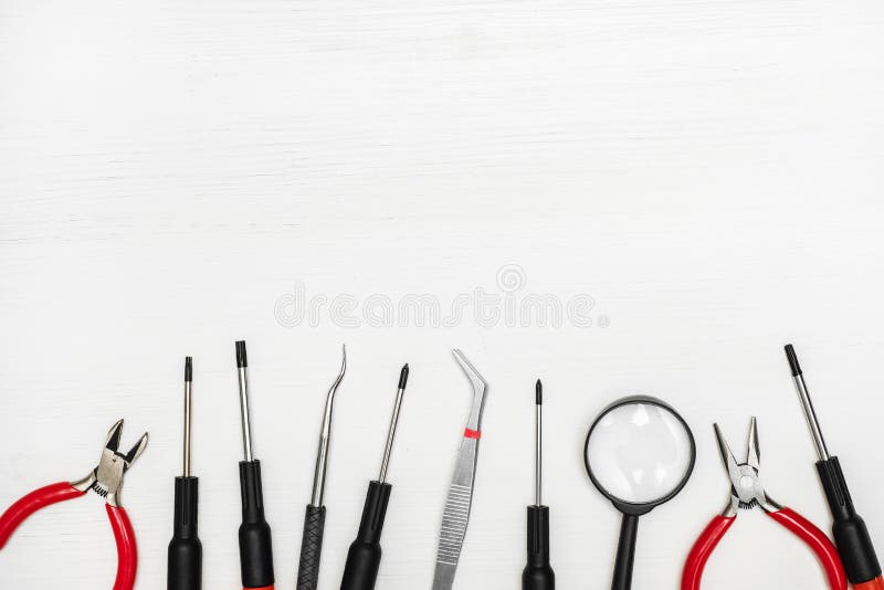 Electronics Repair Tools Are Lined In A Row At The Bottom Of The White ...