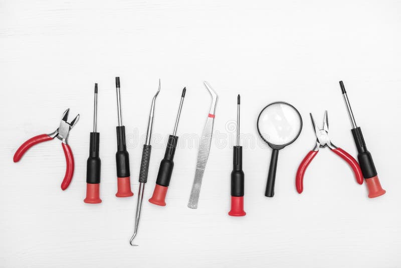 Electronics Repair Tools are Lined in a Row in the Center White ...