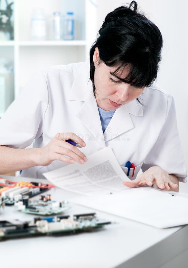 Electronics Repair Worker Reading Stock Photo - Image of paper, alone ...