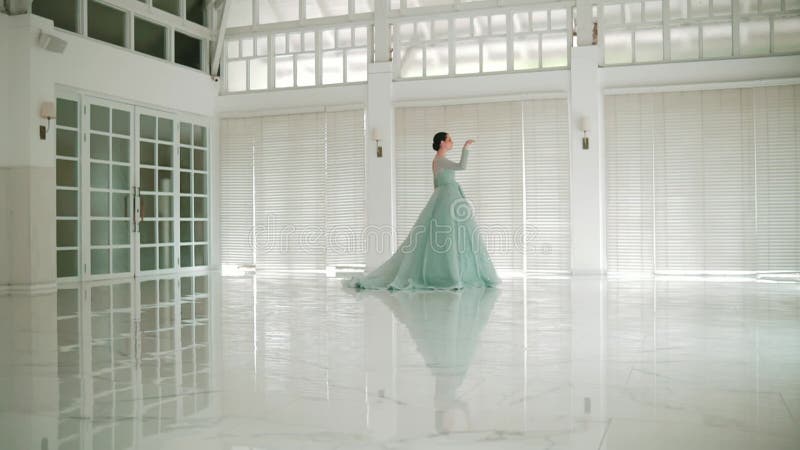 Elegant Ballerina Dancing in a Bright, Spacious Hall with Large Windows ...