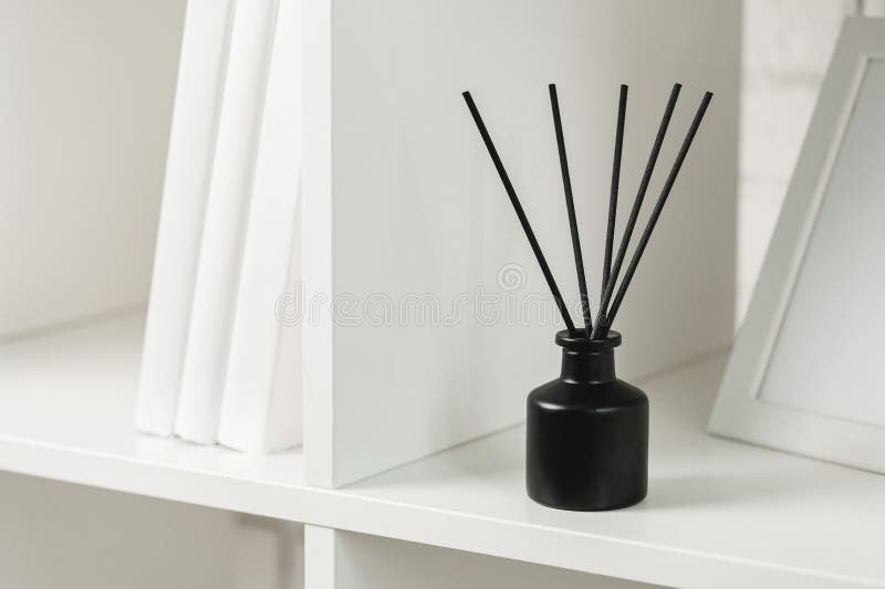 Elegant Black Reed Diffuser on White Shelf in Minimalist Home Decor ...