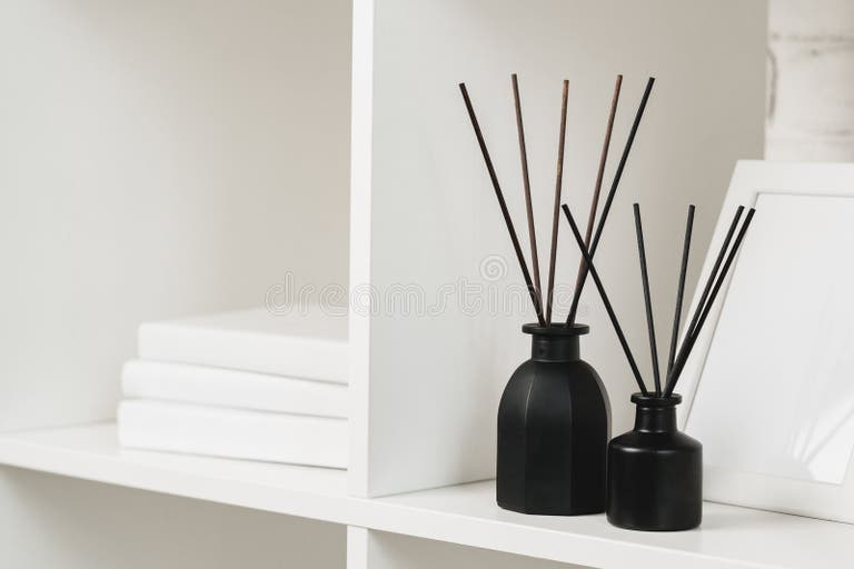 Elegant Black Reed Diffuser on White Shelf in Minimalist Home Decor ...
