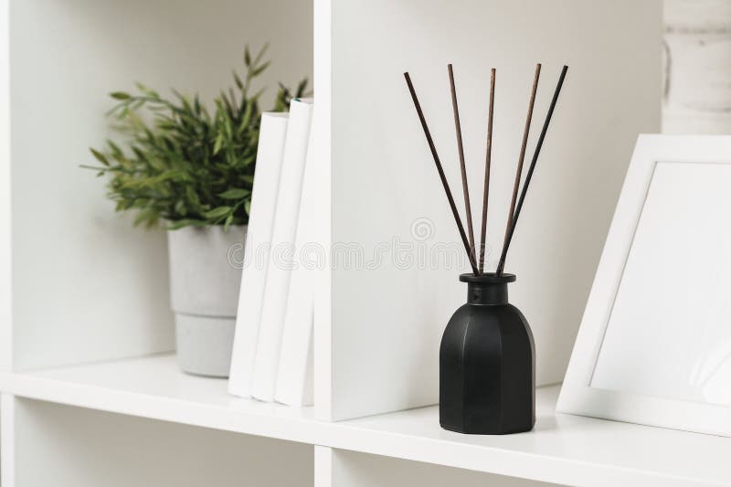 Elegant Black Reed Diffuser on White Shelf in Minimalist Home Decor ...