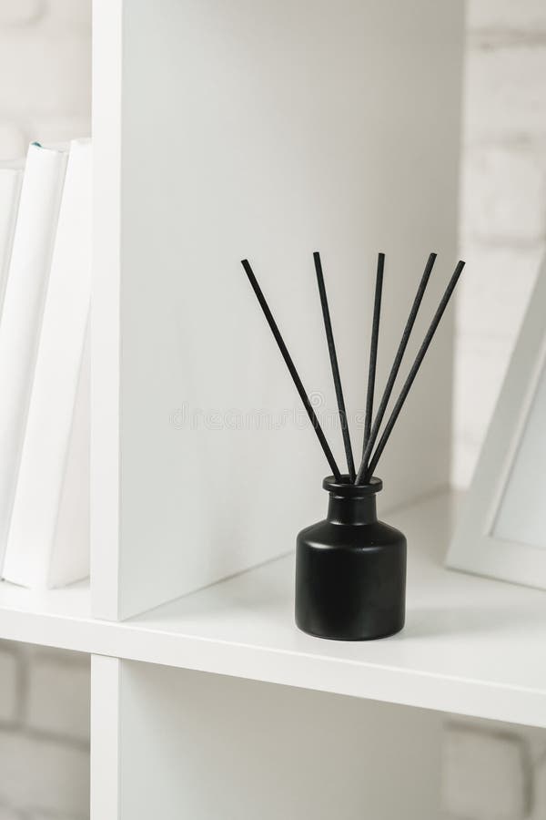 Elegant Black Reed Diffuser on White Shelf in Minimalist Home Decor ...