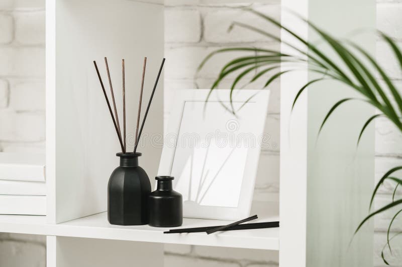 Elegant Black Reed Diffuser on White Shelf in Minimalist Home Decor ...