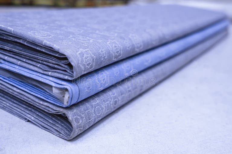 Elegant Blue Fabric Stack: Textured Cotton, Patterned Textiles, Soft ...