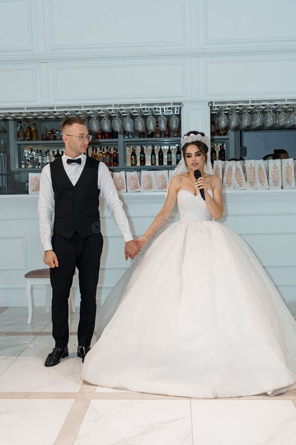 Elegant Bride and Groom Holding Hands during Wedding Reception Speech ...