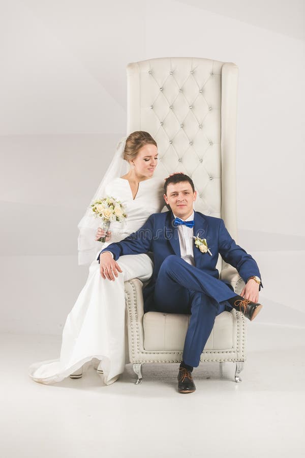 Beautiful Bride Kissing Groom Sitting in Bubble Chair at Studio Stock ...