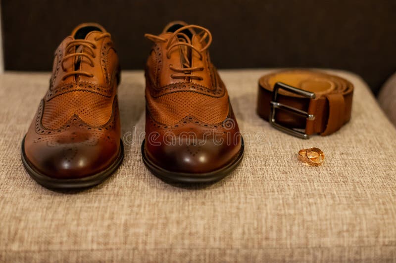 Elegant Brown Leather Shoes with Matching Belt and Ring on Soft Fabric ...