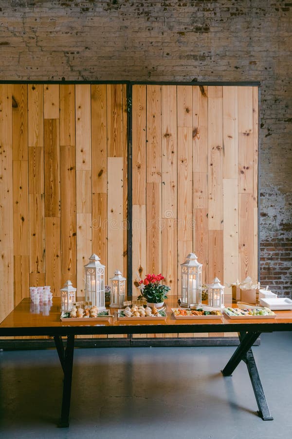 Elegant Buffet Setup Featuring Lanterns and Pastries in a Rustic Venue ...