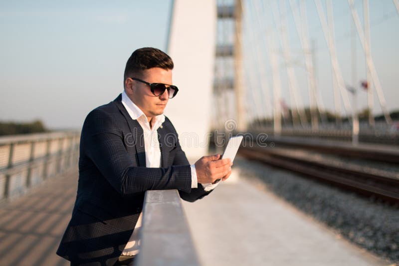 Elegant Businessman Using Smartphone on the Bridge Stock Image - Image ...