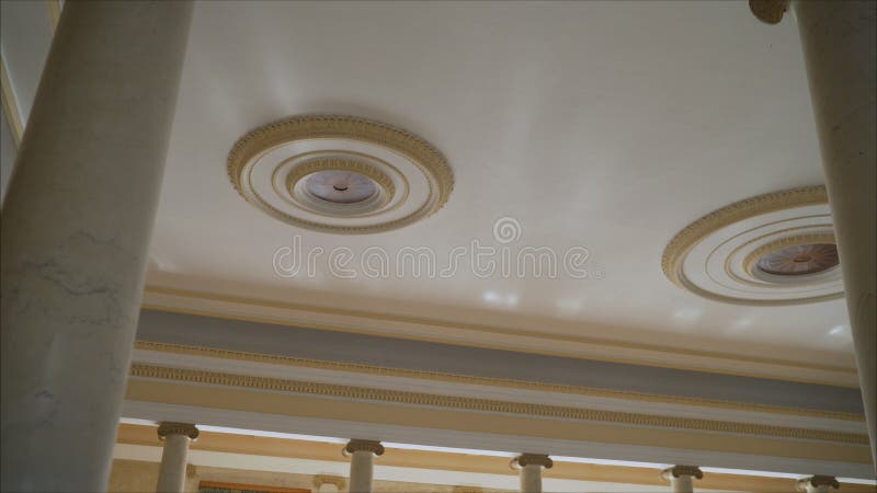 Elegant Ceiling Design with Circular Patterns and Marble Columns in ...