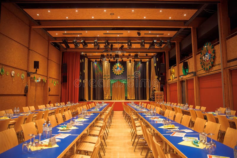 Elegant Conference Room Setup with Blue Tables and Stage Decor ...