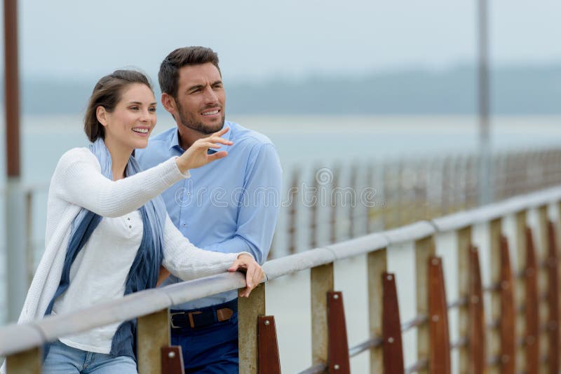 Elegant Couple on Bridge Pointing into Distance Stock Image - Image of ...