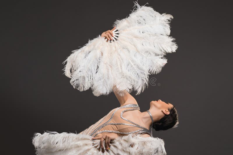 Elegant Dancer Performing with a Feather Fan in a Dramatic Pose Stock ...