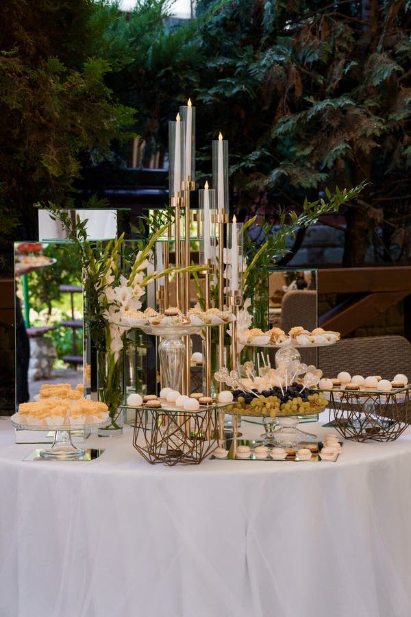 Elegant Dessert Table Setting with Candles and Greenery at Outdoor ...