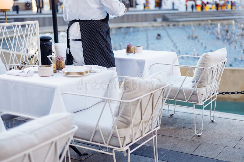 Elegant Dining Setup with White Tablecloth and Decorative Centerpiece ...