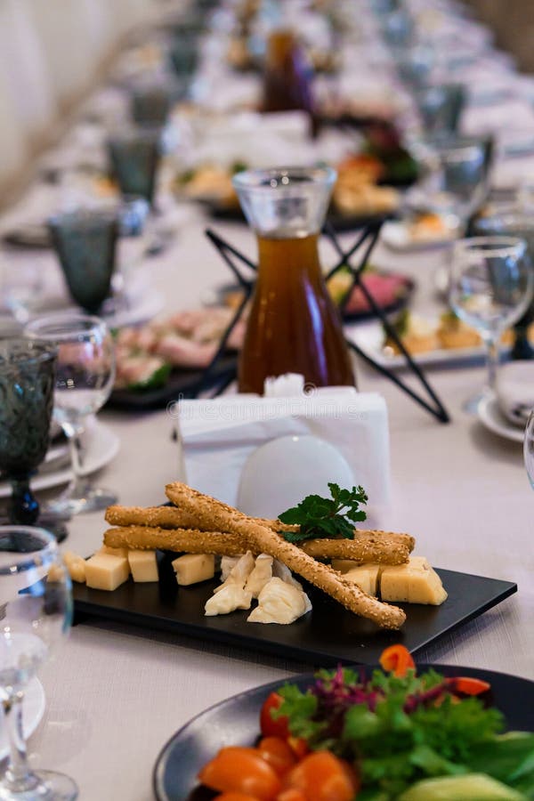 Elegant Dining Table Setting with Assorted Cheese and Fresh Vegetables ...