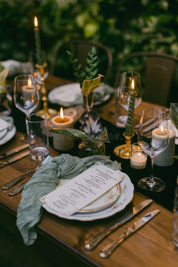 Elegant Dinner Table Setting with Candles and Greenery in an Intimate ...