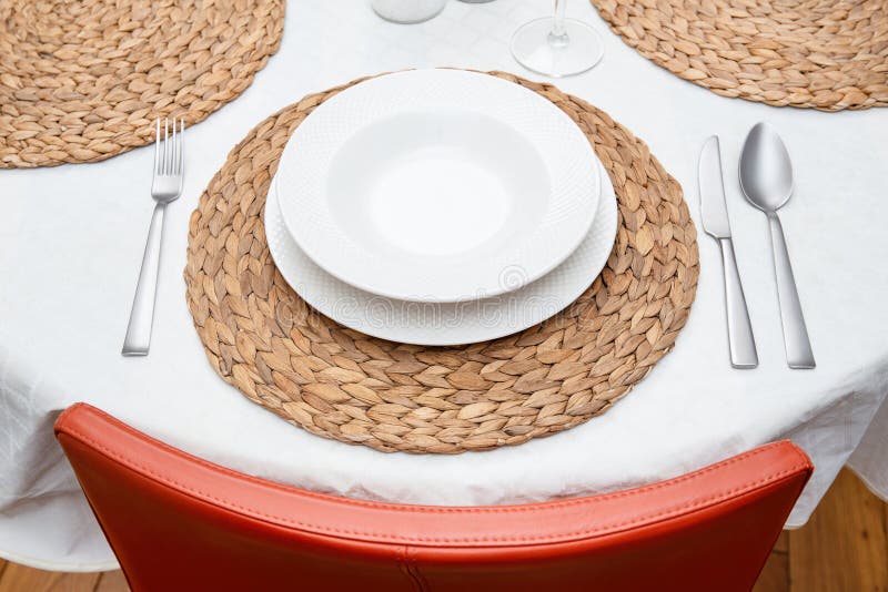 Elegant Table Setting with White Plates and Woven Placemats Stock Photo ...