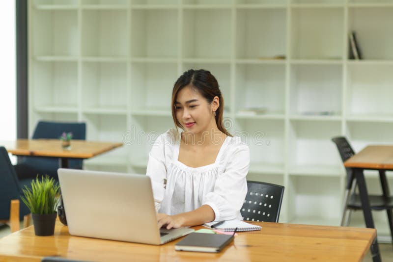 Elegant Female College Student Sitting and Using Laptop Computer in ...