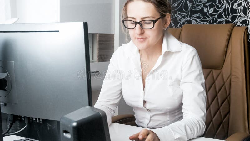 Portrait of Elegant Female Secretary Working in Office on Computer ...
