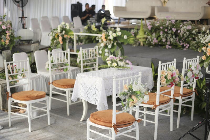 Elegant Floral Wedding Seating Arrangement with Decorated Chairs and ...