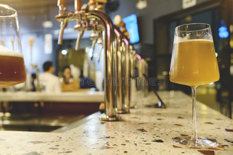 Elegant Glass of Craft Beer and Taps. Beer Taps in a Row in Perspective ...