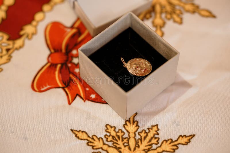 Elegant Gold Pendant in a Gift Box on Decorative Fabric Stock Photo ...