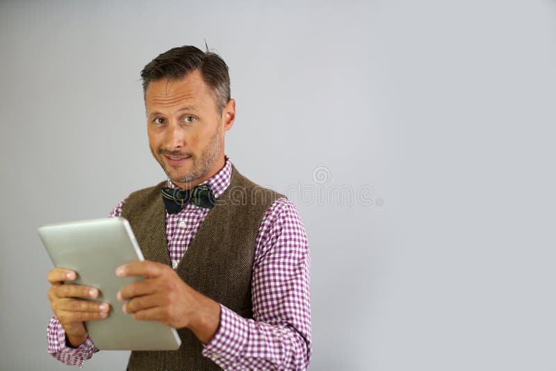 Elegant guy using tablet stock image. Image of mature - 33369305