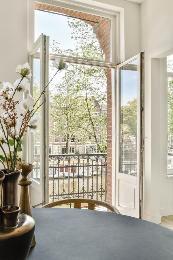 Elegant Interior with Open Windows and Floral Decor Stock Photo - Image ...