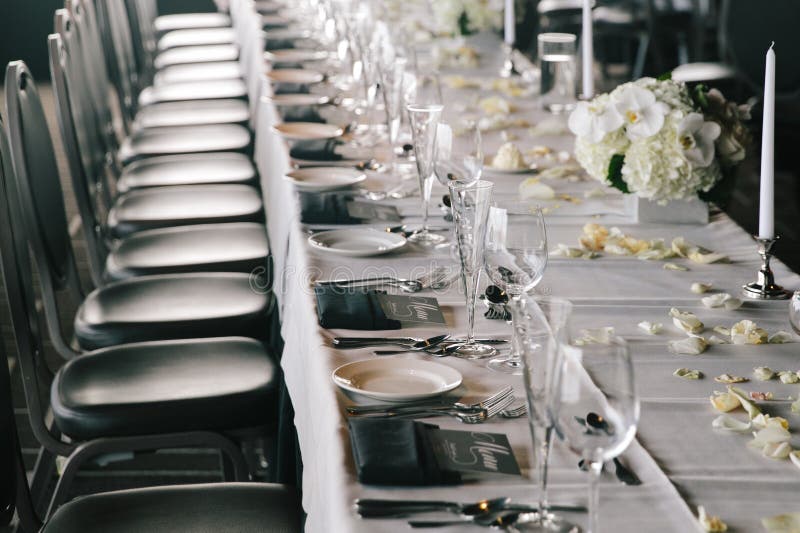 Elegant Long Table Setting for a Formal Event Featuring White Floral ...