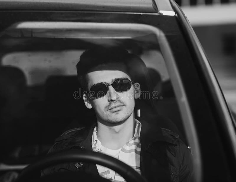 Elegant man drives a car stock photo. Image of customer - 184763342
