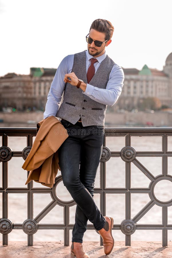 An Elegant Man Standing Next To a River and Checking the Time Stock ...