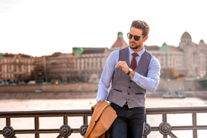 An Elegant Man Standing Next To a River and Checking the Time Stock ...