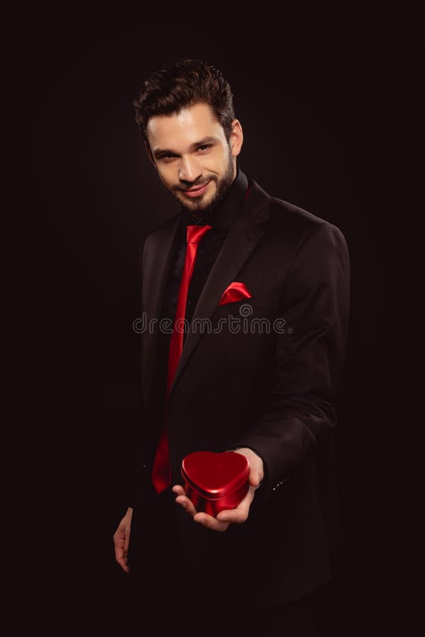 Elegant Man in Suit Holding Gift Box in Heart Shape and Looking at ...