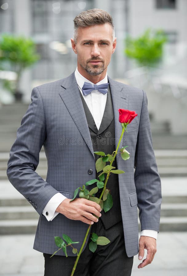 Elegant Man in Tuxedo at Romantic Occasion. Man with Romantic Present ...