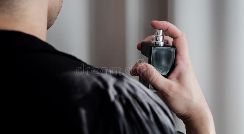 Elegant man using perfume stock photo. Image of cosmetic - 264871062